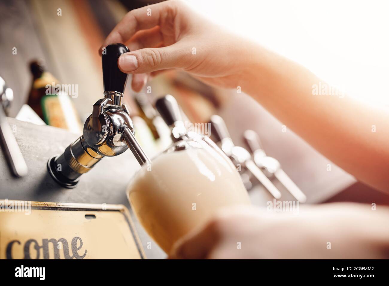 Light Draft cold beer pour in glass from crane in pub Stock Photo - Alamy