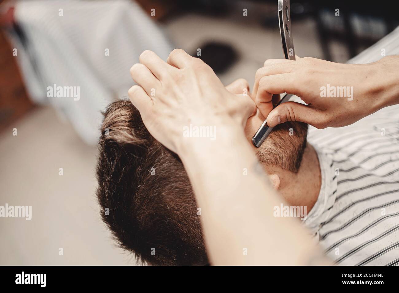 Barber process shaving razor bearded hipster man in barbershop Stock ...