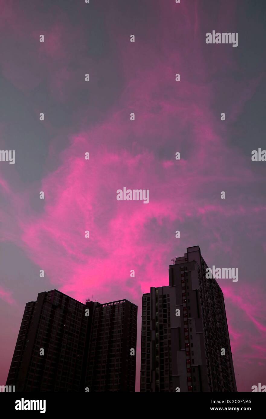 Fantastic sunset sky over the city in pop art style vibrant pink color ...