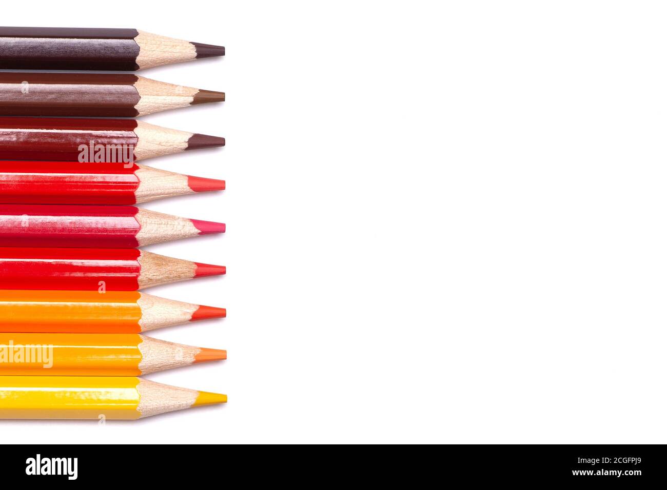 multi-colored wooden pencils in red shades on a white isolated ...