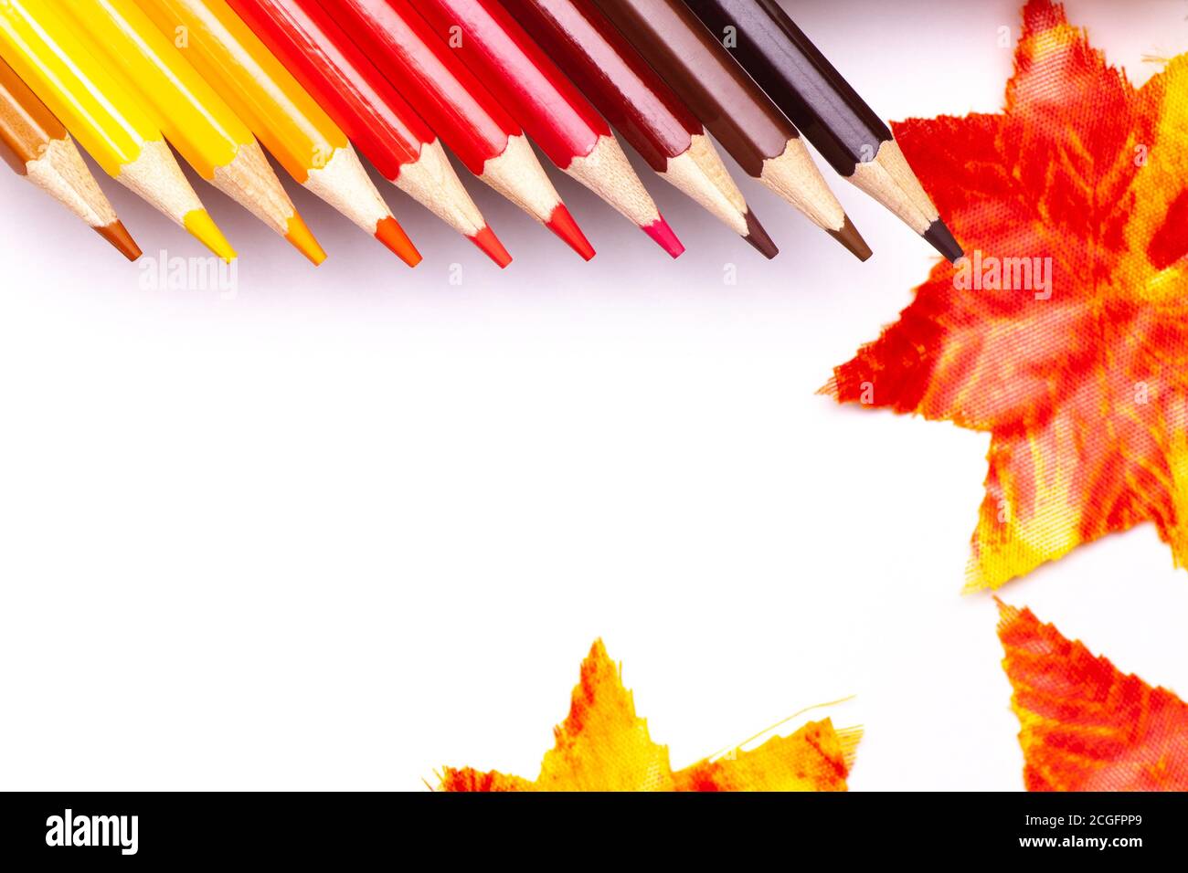 multi-colored wooden pencils in red shades on a white isolated ...