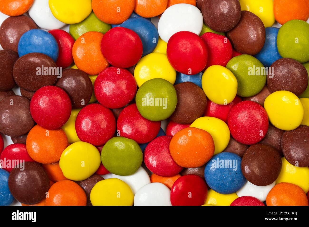 Multicolored hard shell chocolate candies in a top view Stock Photo - Alamy