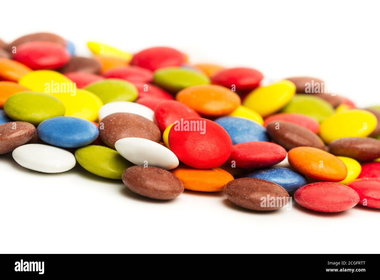 Multicolored hard shell chocolate candies isolated on a white ...