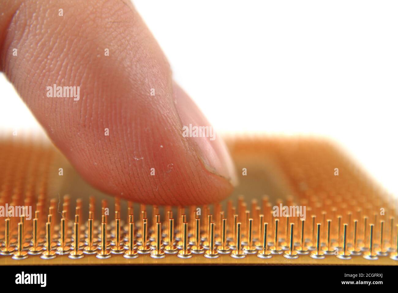 old microprocessor and human hand isolated on the white background ...