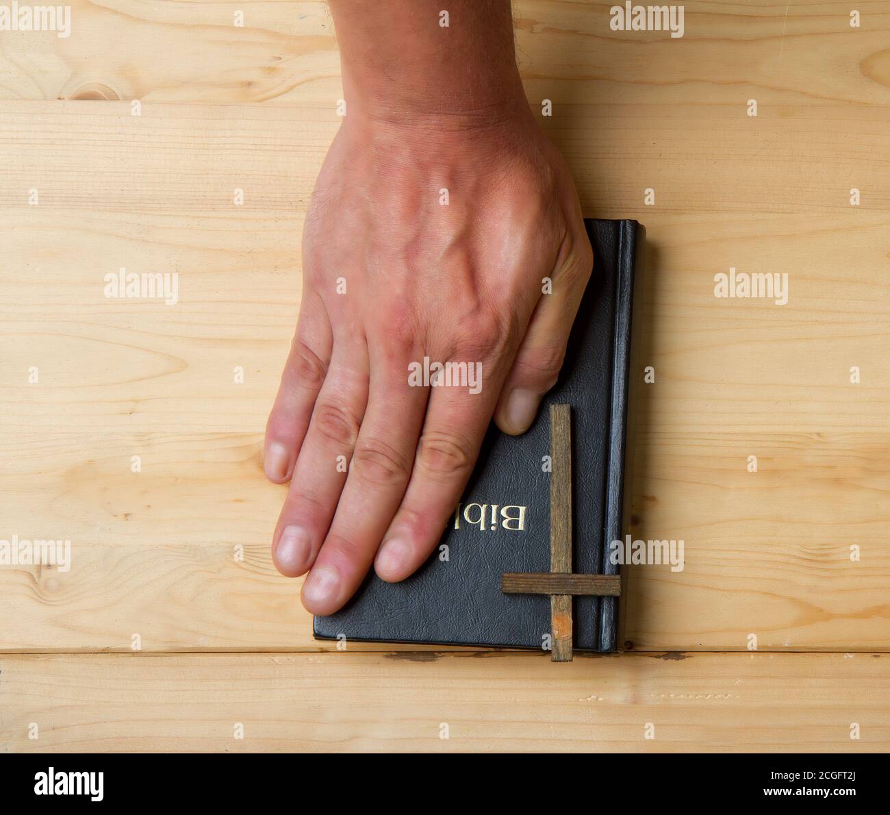 the hand of an adult man lies on the bible as a sign that he is telling ...