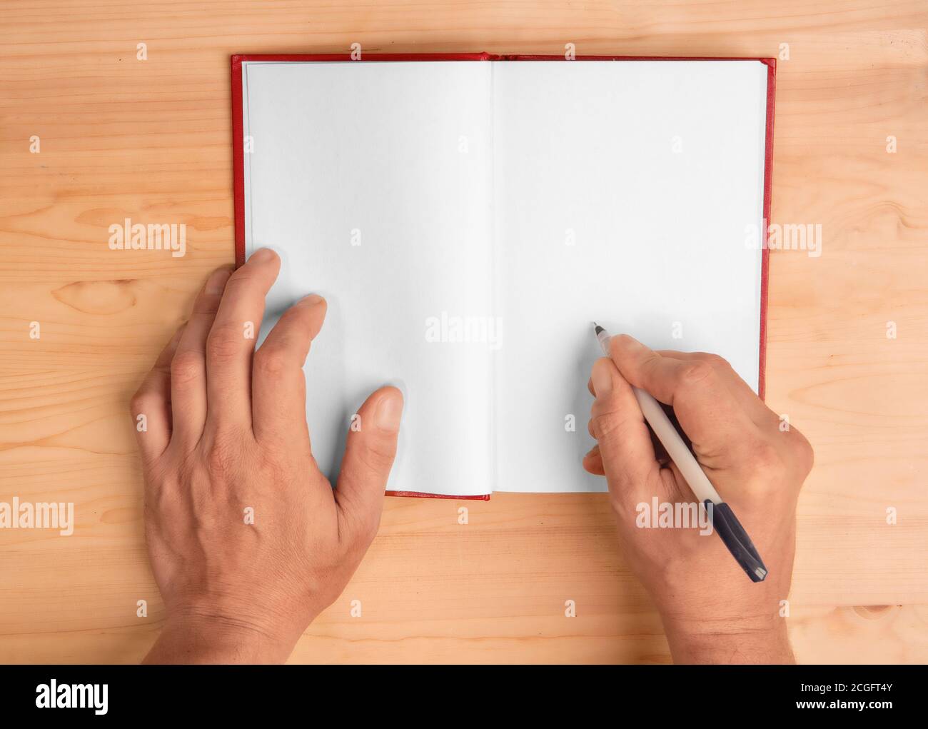hands of the author giving autograph on the page of his book top view ...