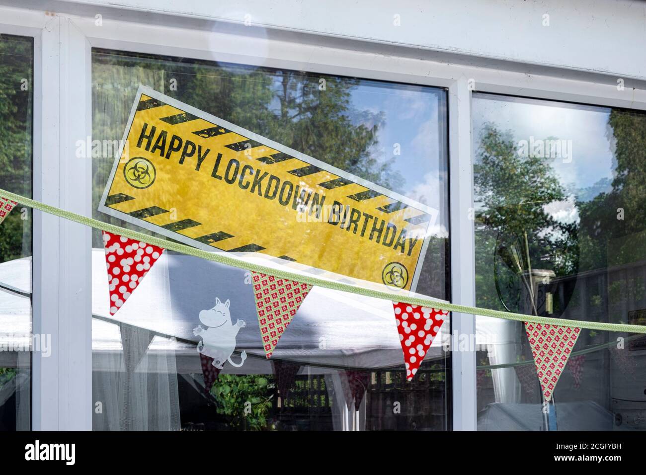 Party bunting and banners at an outdoor socially distanced birthday ...