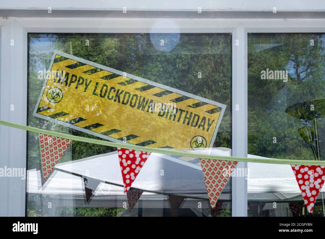 Party bunting and banners at an outdoor socially distanced birthday ...