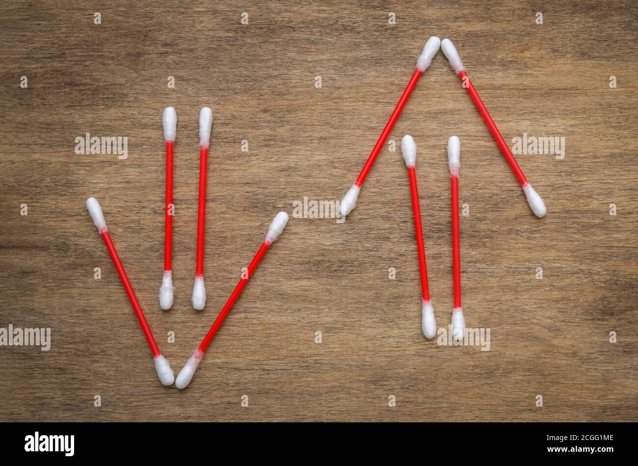 Plastic cotton swabs, arrow sign; Direction sign on wooden background ...