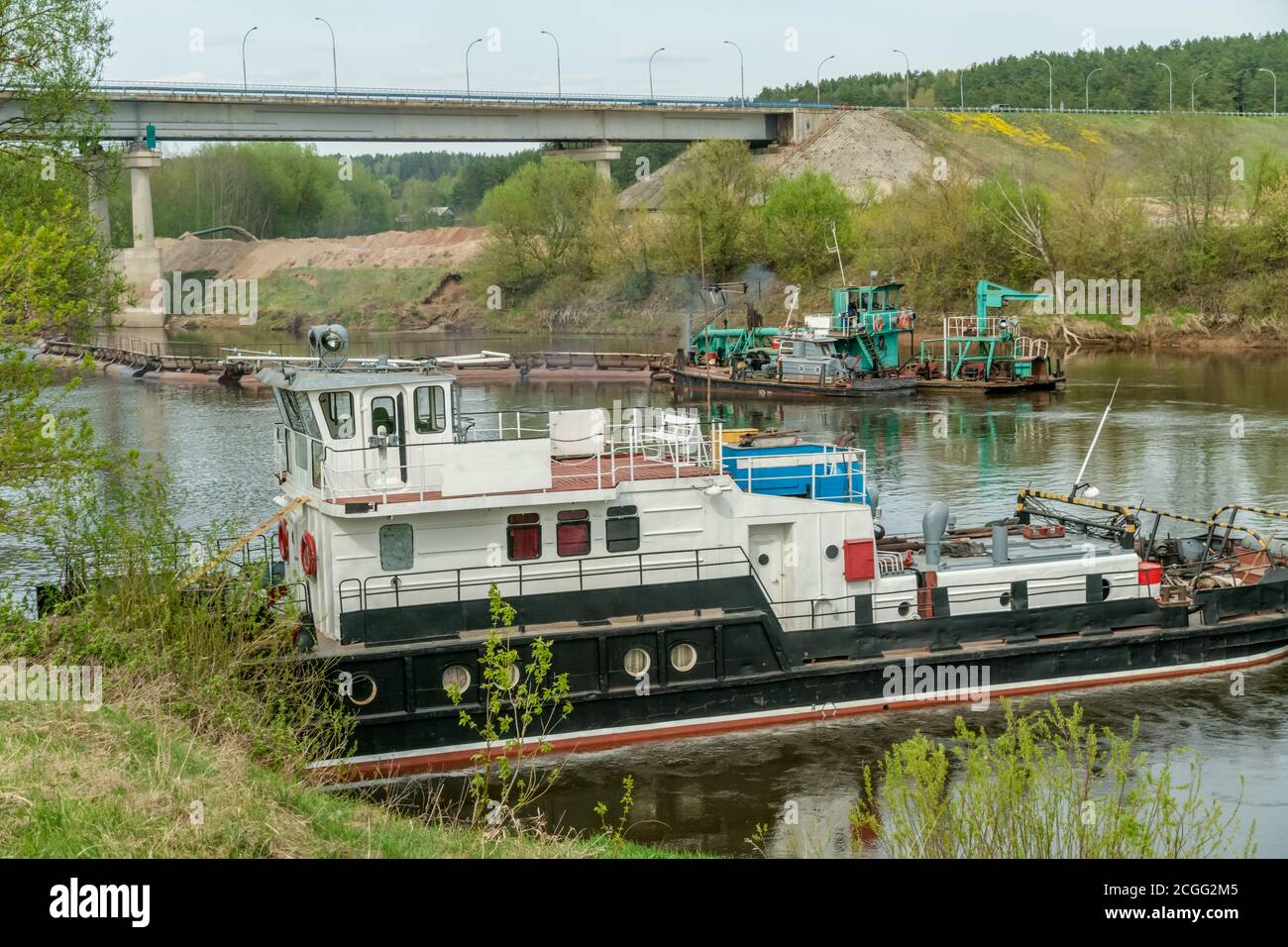old tug on the river on the background of the bridge Stock Photo - Alamy