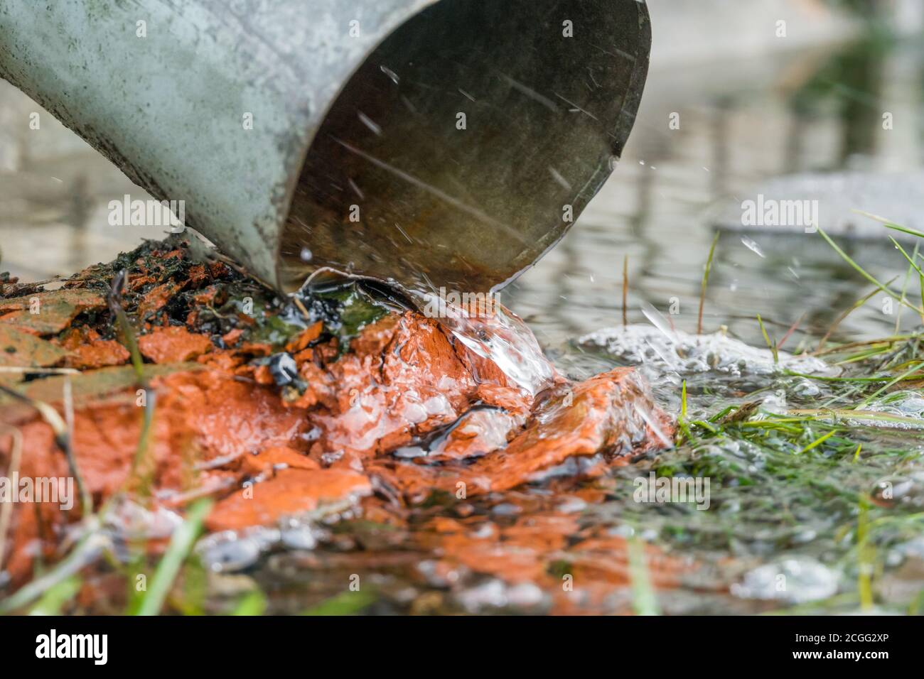 Heavy rain outdoors. Drains are filling with water. Gutter pipes ...
