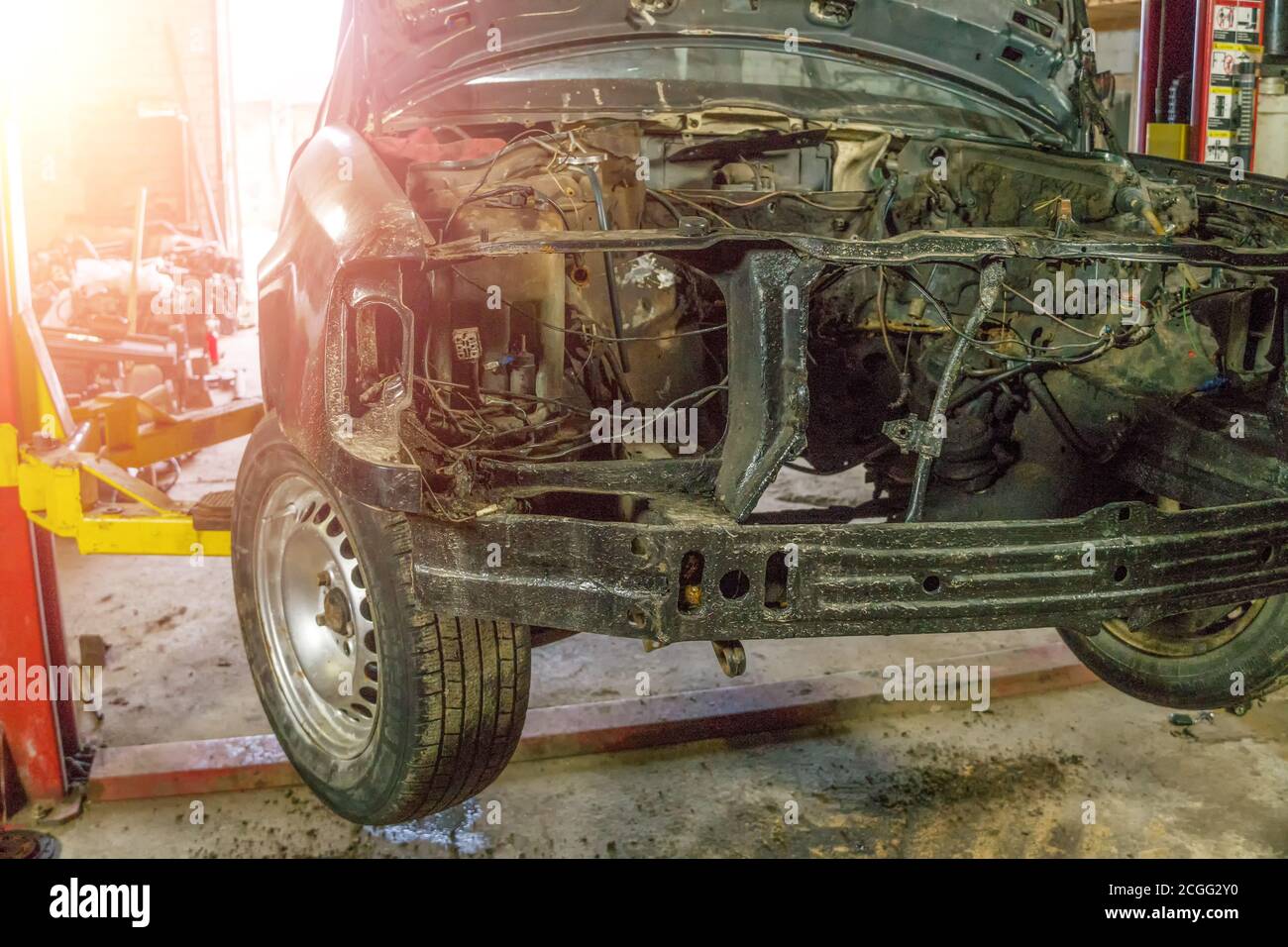 Disassembled car on a lift, car repair Stock Photo - Alamy