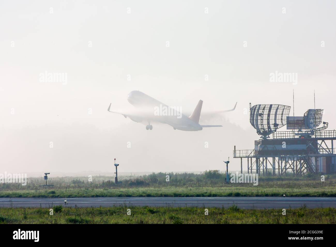 Incredible airplane taking off in fog Stock Photo - Alamy