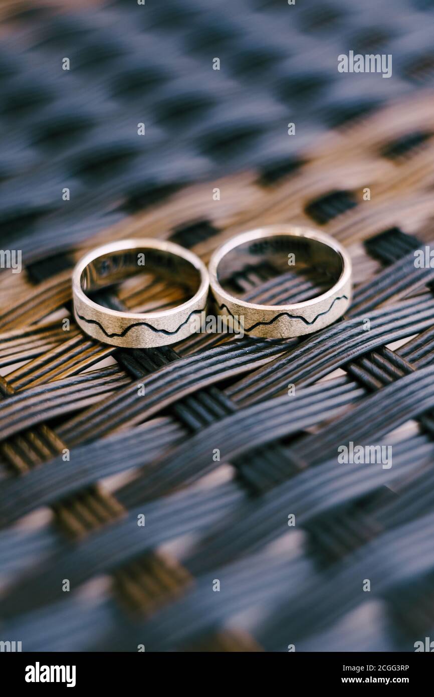 Gold wedding rings patterned on a gray woven texture Stock Photo - Alamy