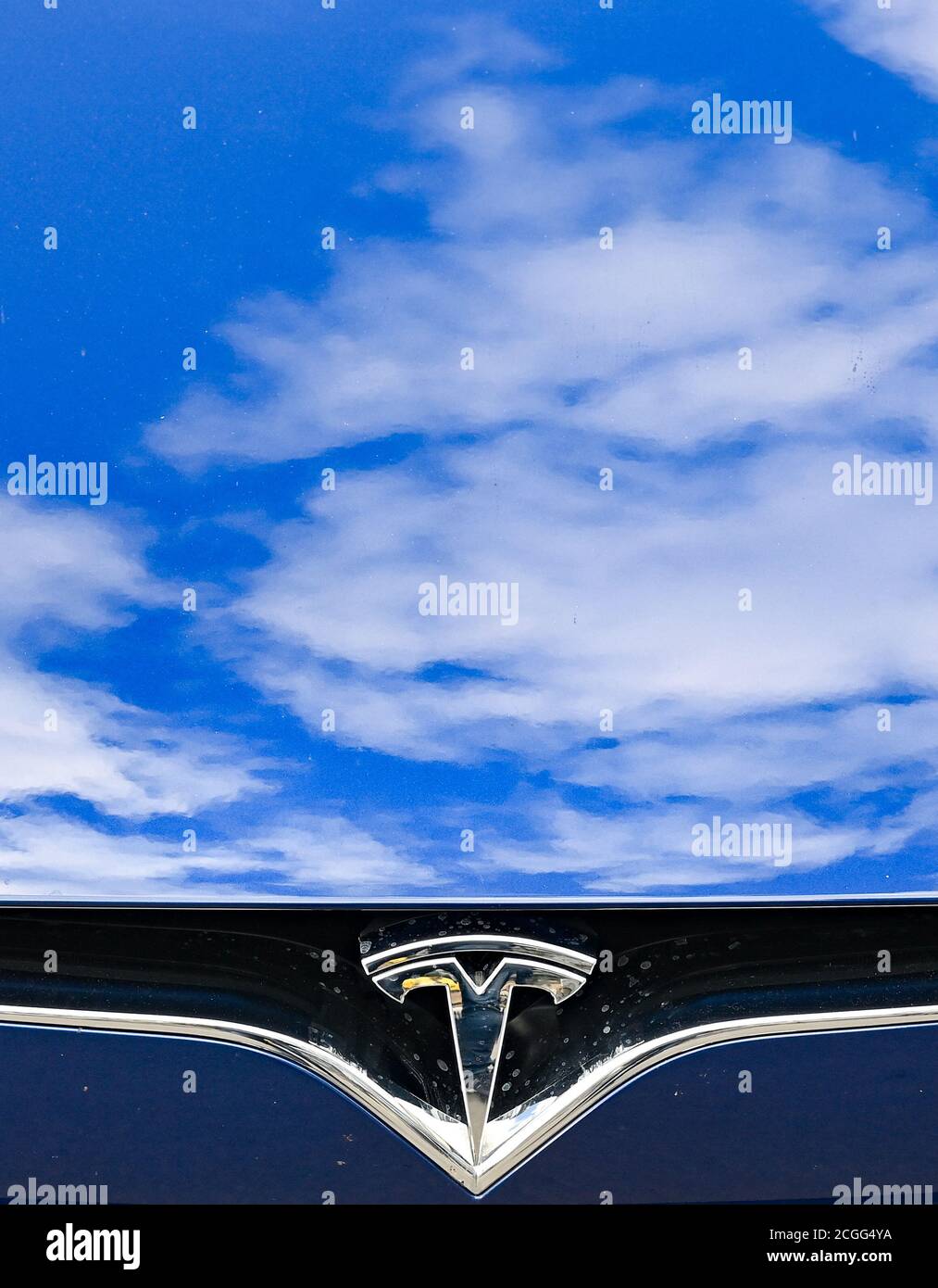 10 September 2020, Berlin: Tesla's logo on a car with the clouds ...
