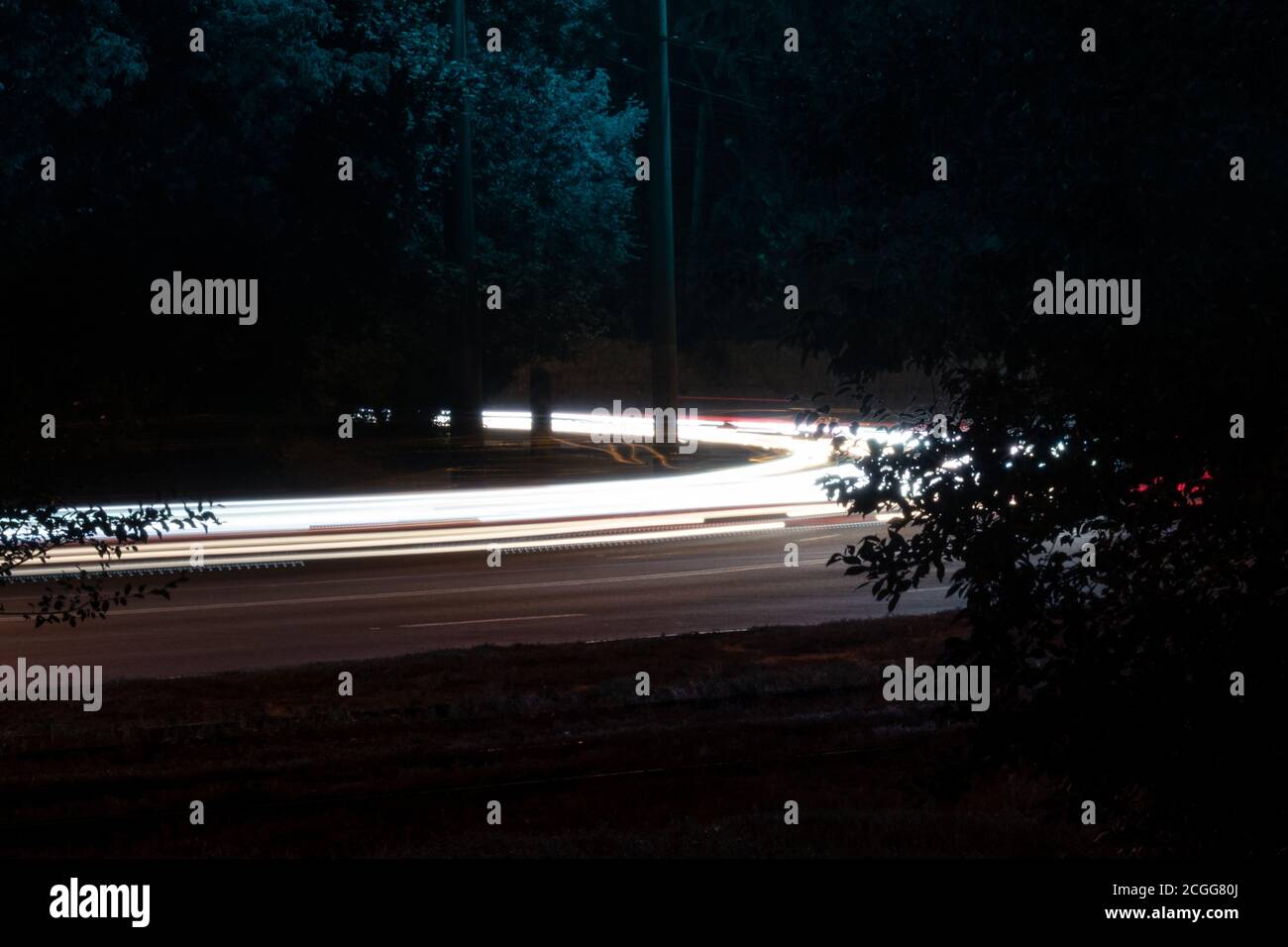 Cars white bright night lights on road highway band on long exposure ...