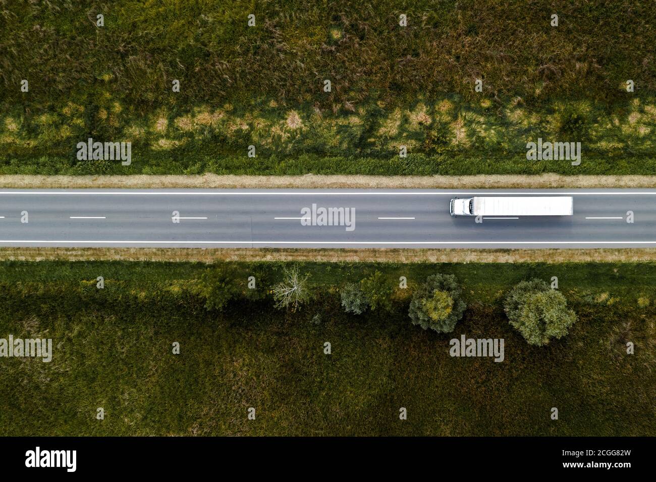 Large freight transporter semi-truck on the road, aerial view top down ...