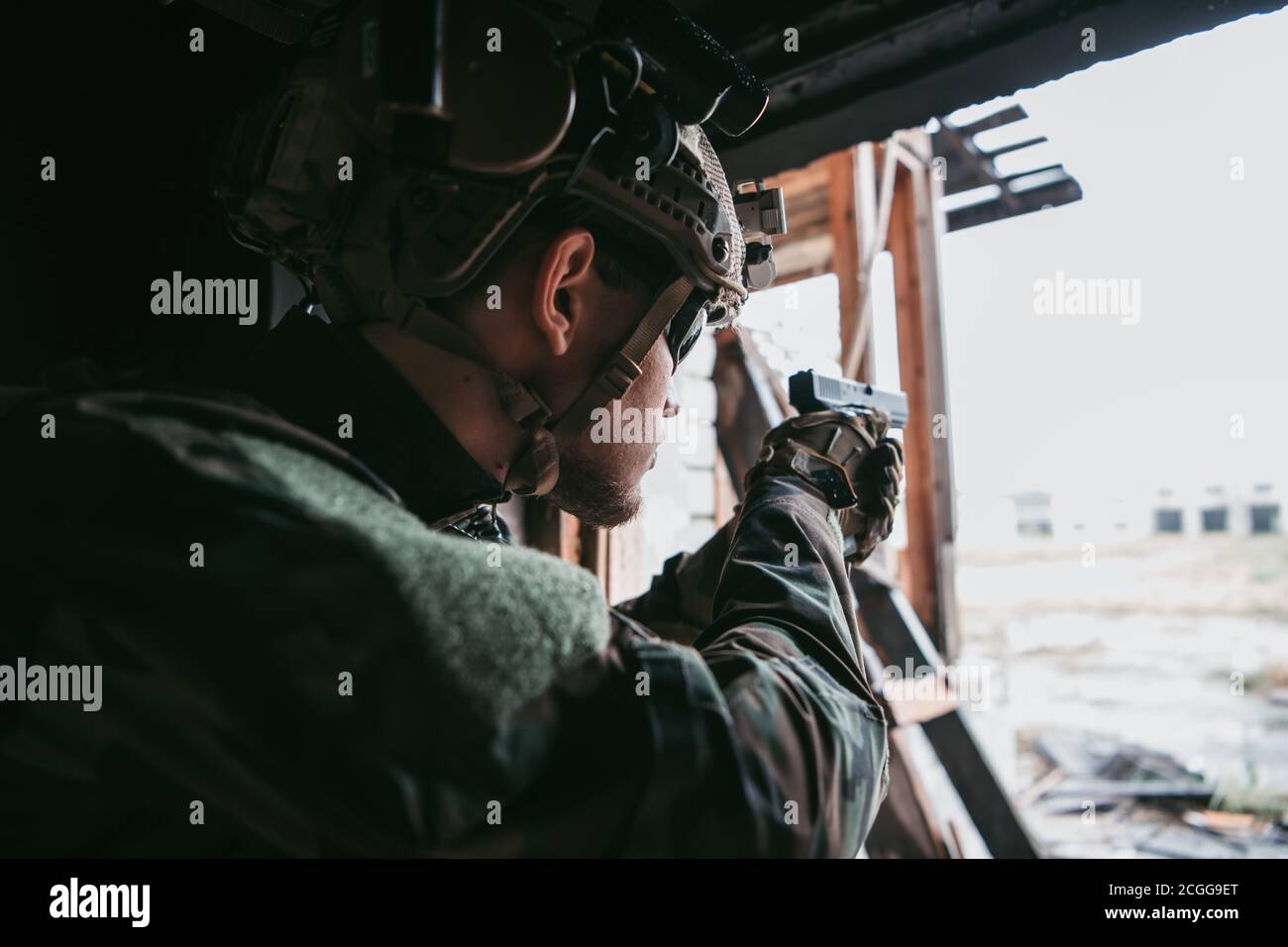Soldier in combat. Urban combat training, soldier entering abandoned ...
