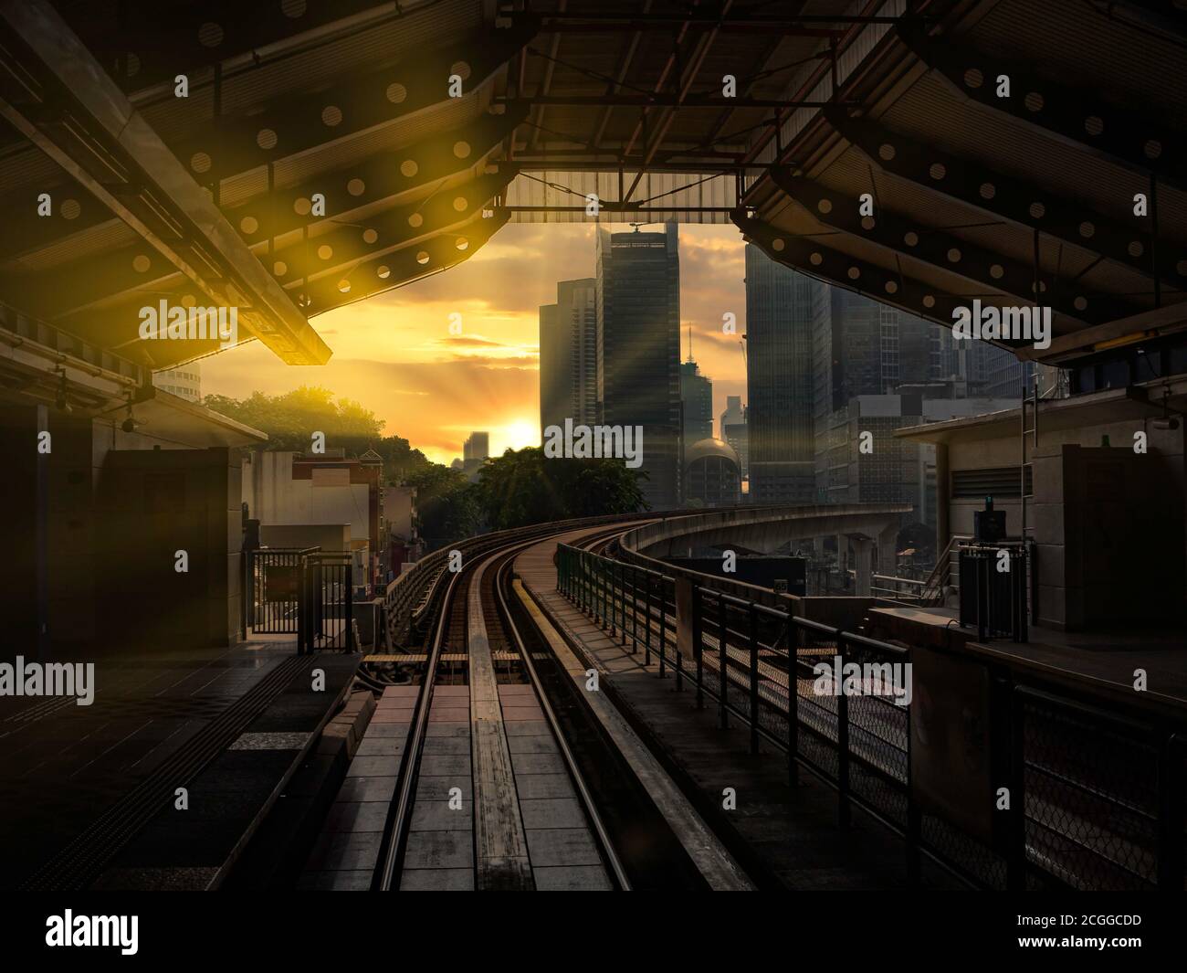 Going to work by train under a bright sunny sunrise with the cityscape ...