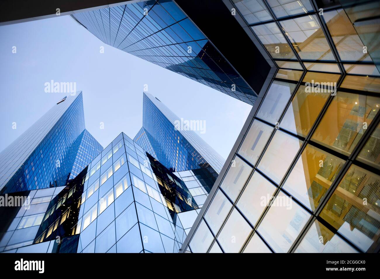 Up view of blue modern headquarters building reflected each other under ...