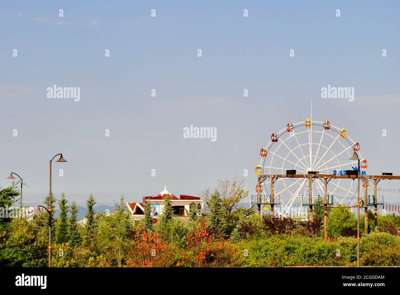 The observation wheel tourist attraction facing mountain ranges. Gebele ...
