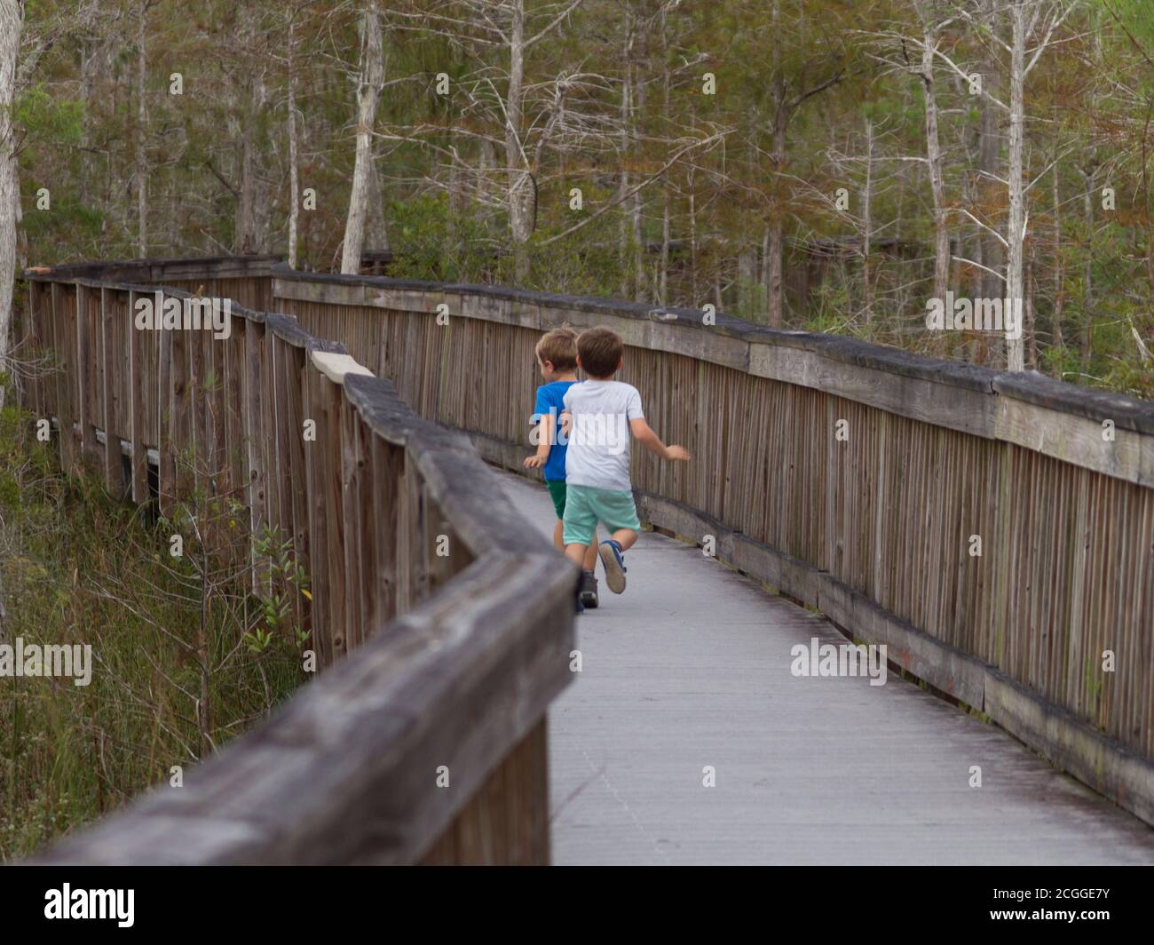 boy running on bridge Stock Photo - Alamy