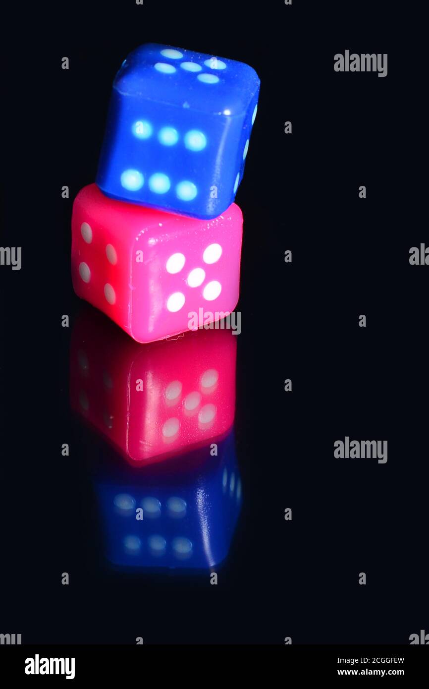 A pair of different colored dice are placed vertically on reflecting ...