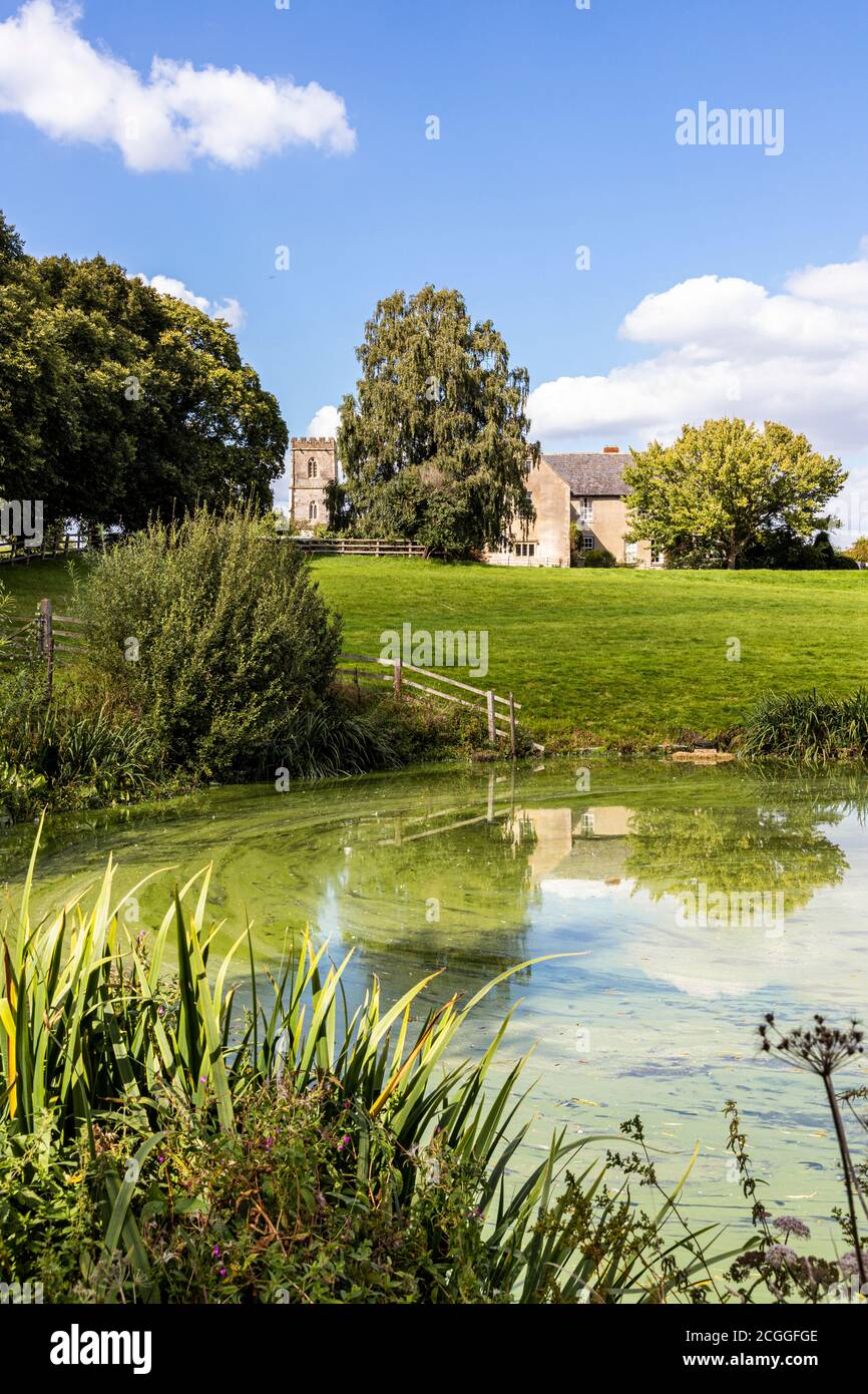 Maisemore Court and St Giles church viewed across the lake in the ...