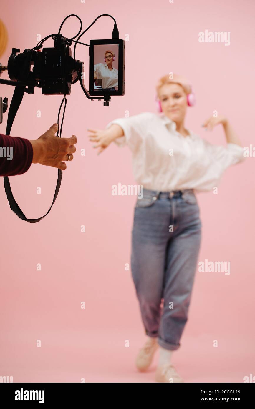 Image in field monitor of a young woman dance-walking towards the ...