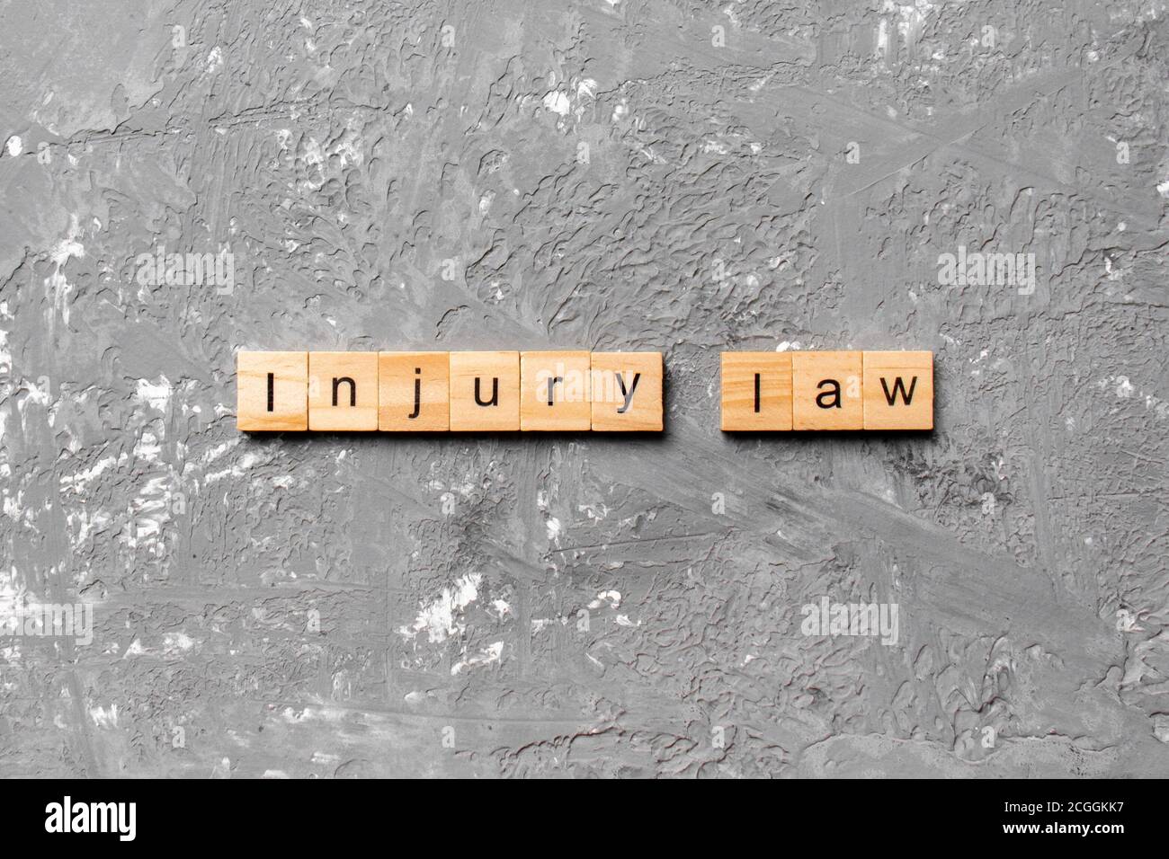 INJURY law word written on wood block. INJURY law text on table ...