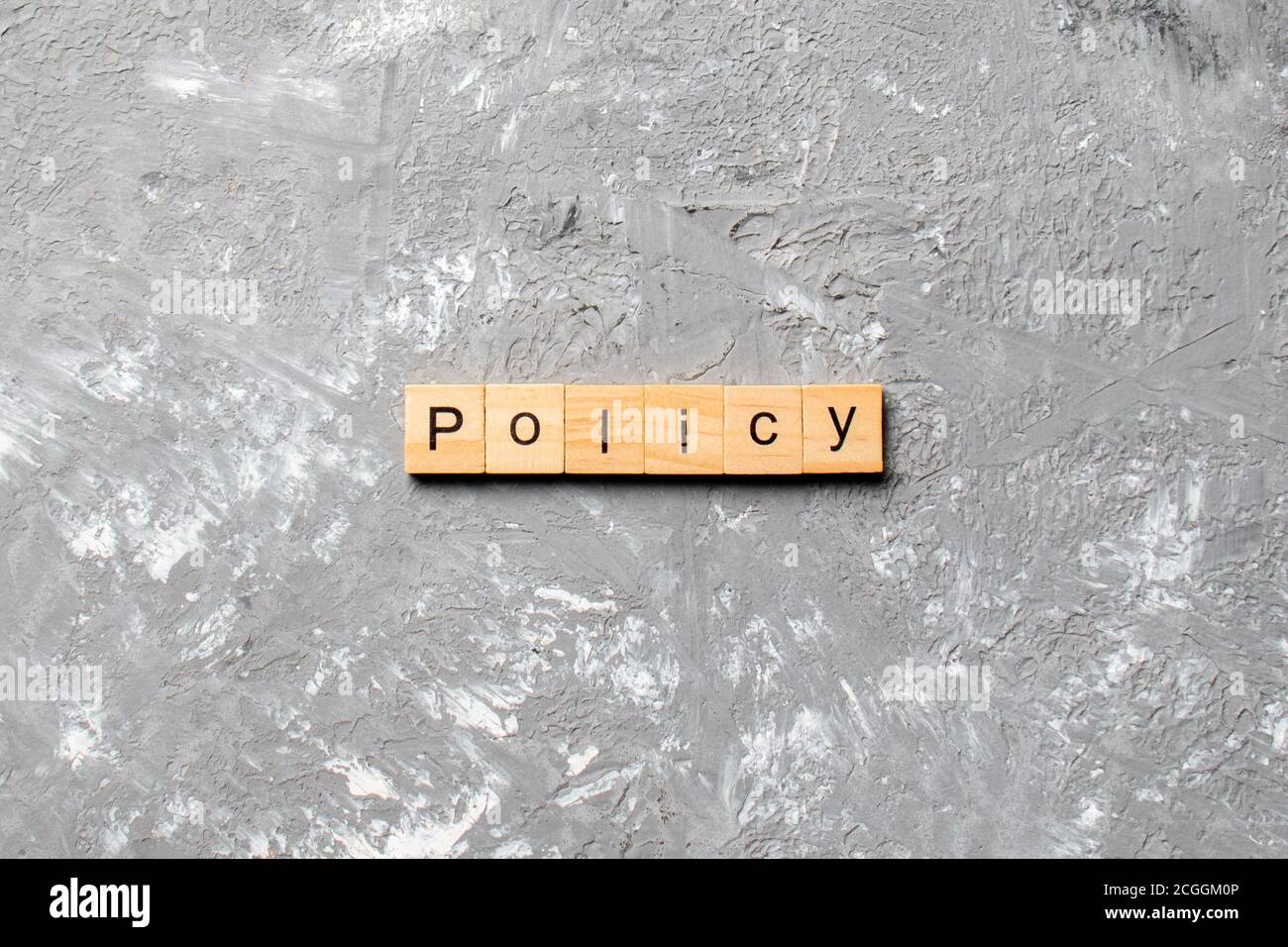 Policy word written on wood block. Policy text on cement table for your ...