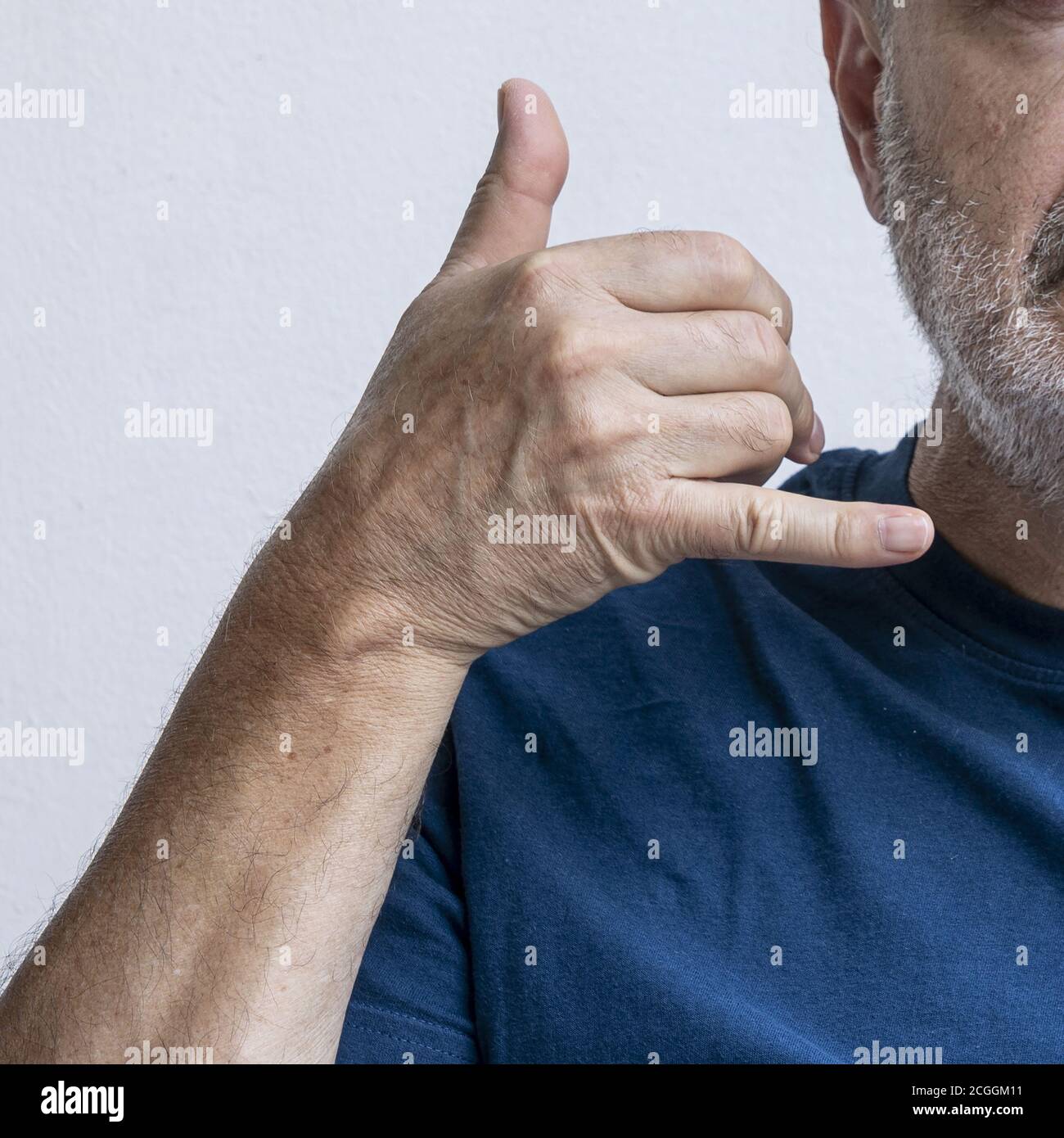 a man gesturing to receive a phone call Stock Photo - Alamy