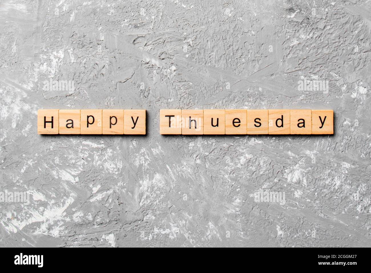 Happy Tuesday word written on wood block. Happy Tuesday text on cement ...