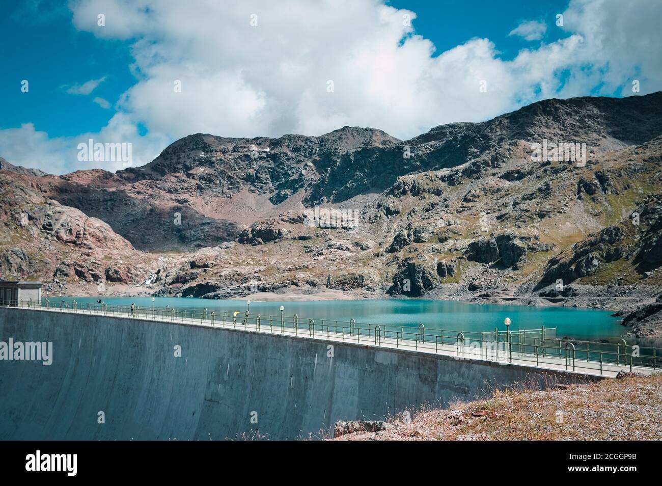 A reinforced concrete dam of an artificial lake in the Italian Alps ...