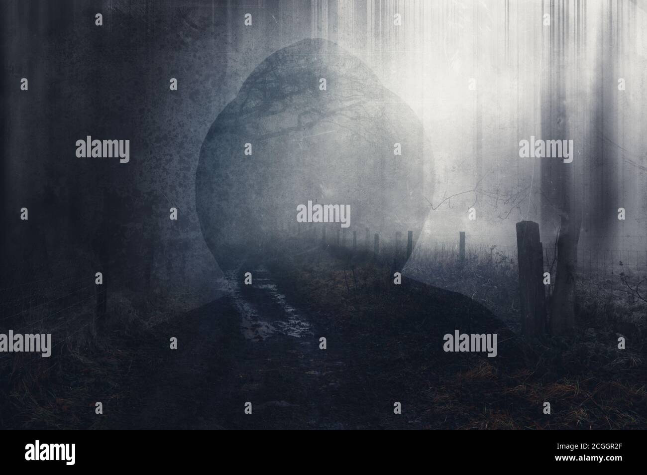 A double exposure of a scary hooded figure with no face. Over layered ...