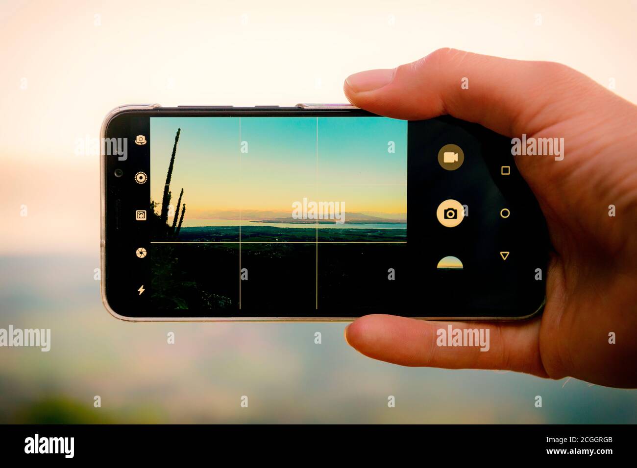 Smartphone photography. Hand holding smartphone to take a picture of a ...