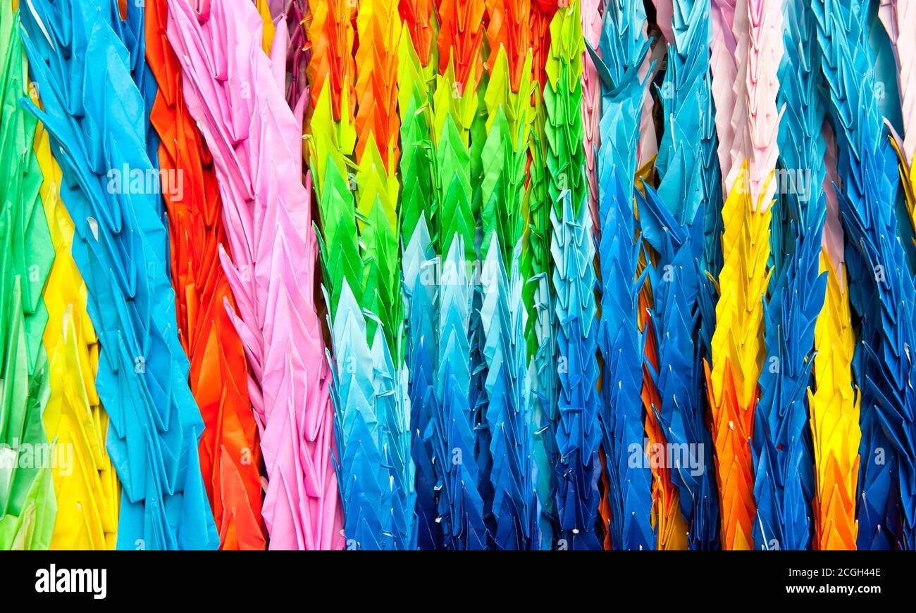 Colorful chains of origami cranes remind of a nuclear blast in Nagasaki ...