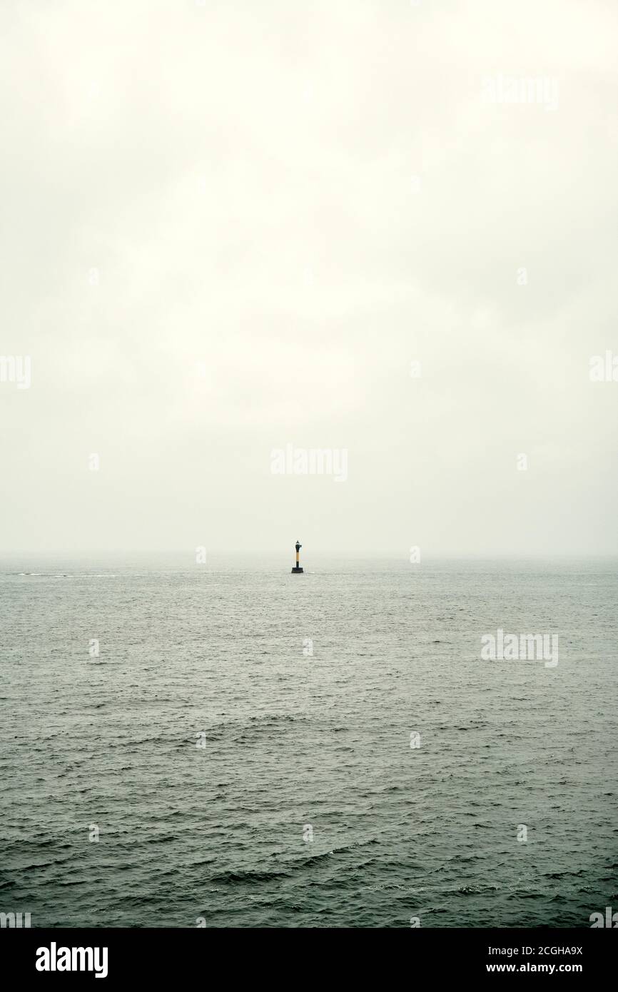 Small Isolated Lighthouse in the Distance Stock Photo - Alamy