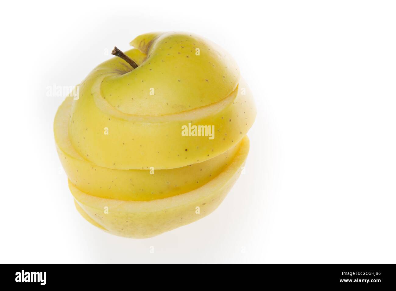 an yellow apple cut into slices over white background Stock Photo - Alamy