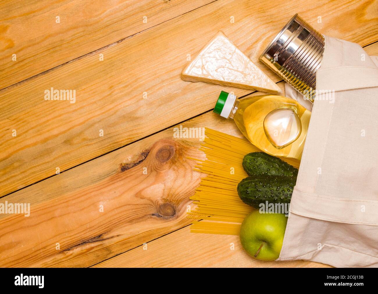 Food donations in a cloth bag on a wooden background in the corner, top ...