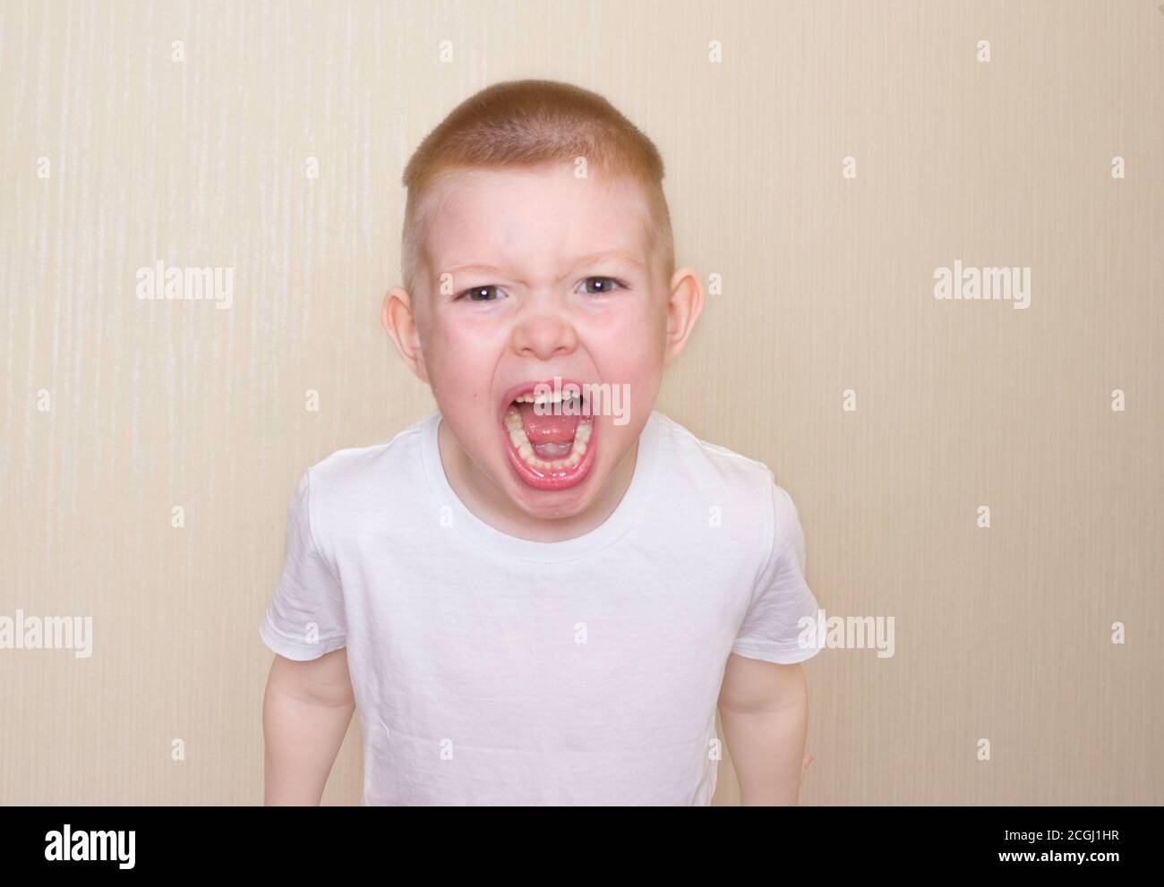 Concept of child aggression, problems with upbringing. An angry boy ...