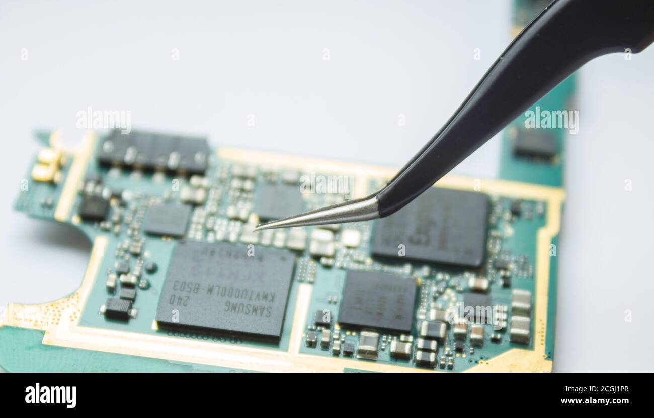 Phone repair. Electronic Board inside the phone. Close, white ...