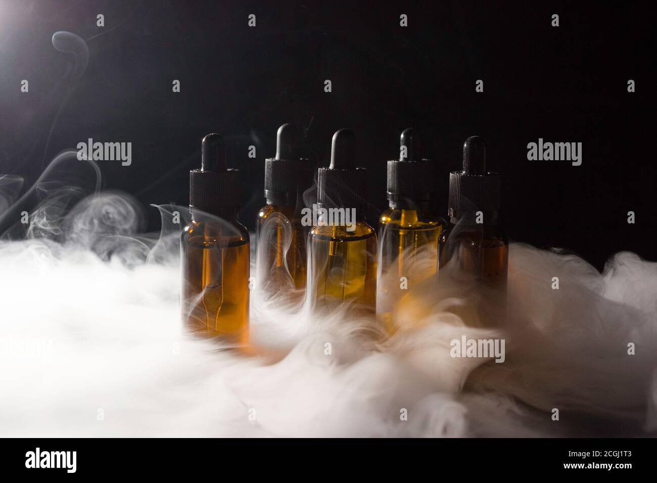 Glass bottles with pipettes and VAPE liquid. Thick vapor from Smoking ...