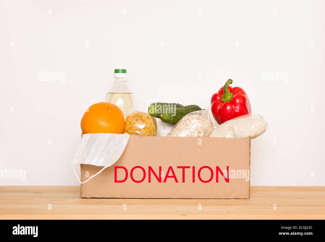 Donation box with various food. Open cardboard box with oil, canned ...