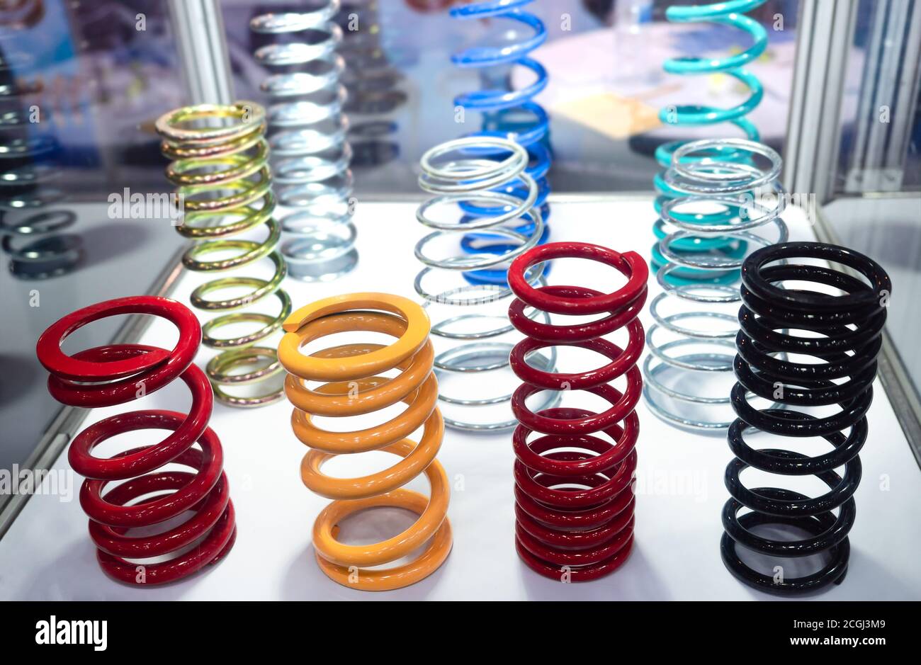 Multi-colored steel springs are displayed in the cabinet. Used in ...