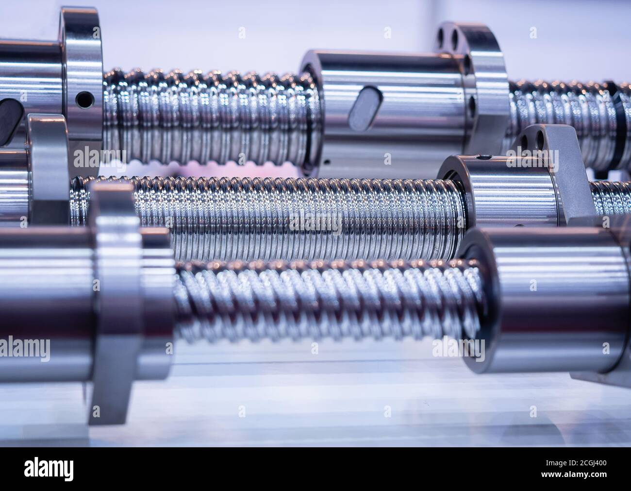 Steel rod with a screw thread and a metal round detail, in industrial ...