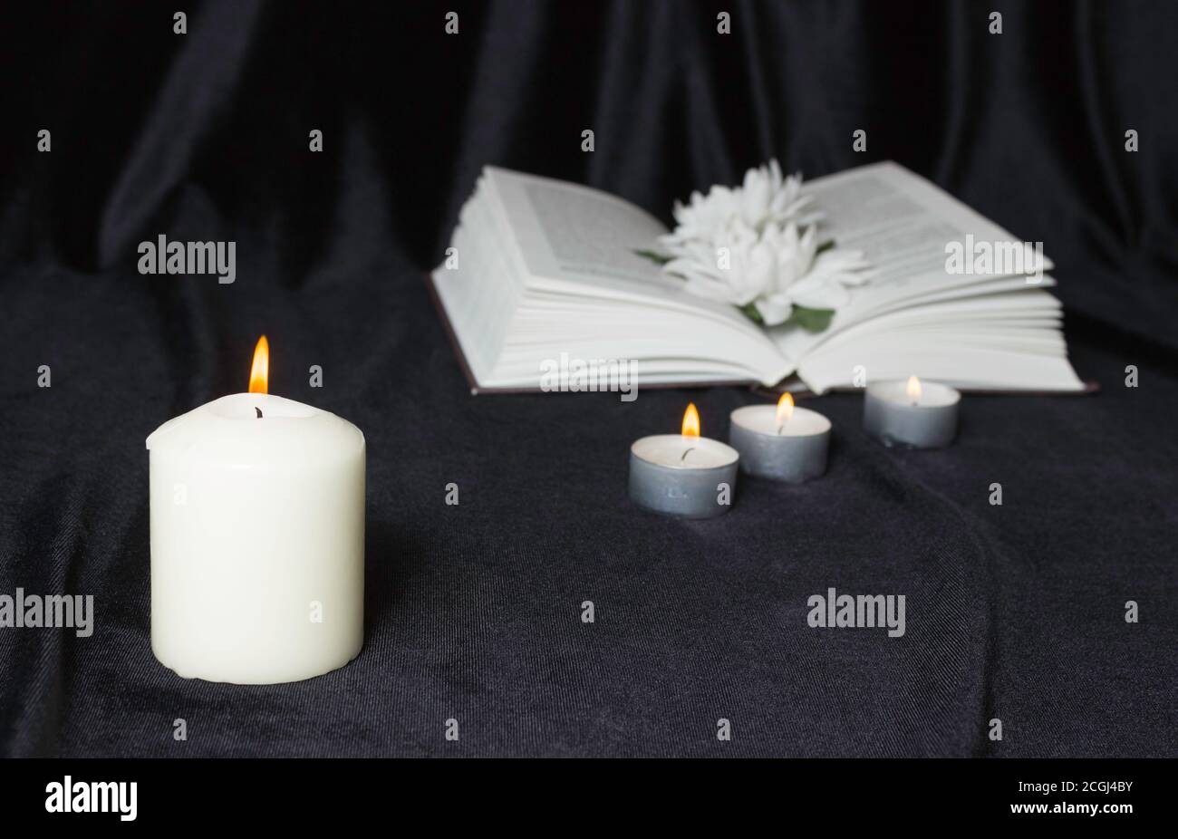 Condolence card. A white memorial candle with white flowers and an open ...