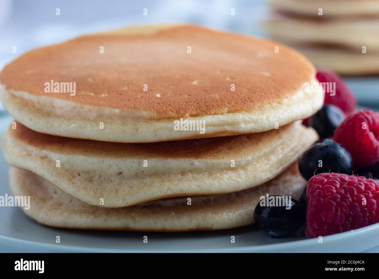 Fluffy pancake stack with raspberries and blueberries Stock Photo - Alamy