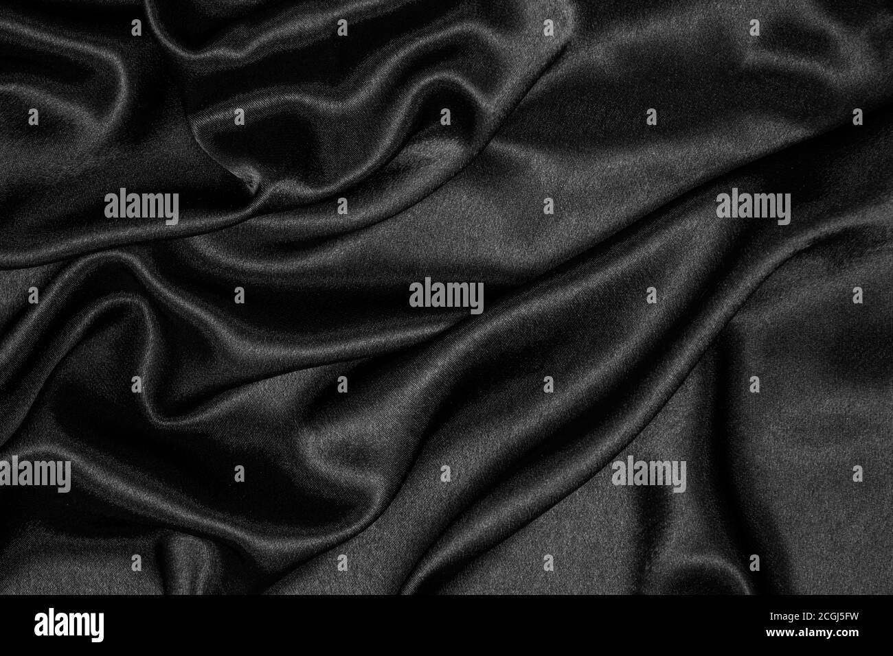 Smooth elegant black silk or satin luxury cloth texture can be used as abstract background ...