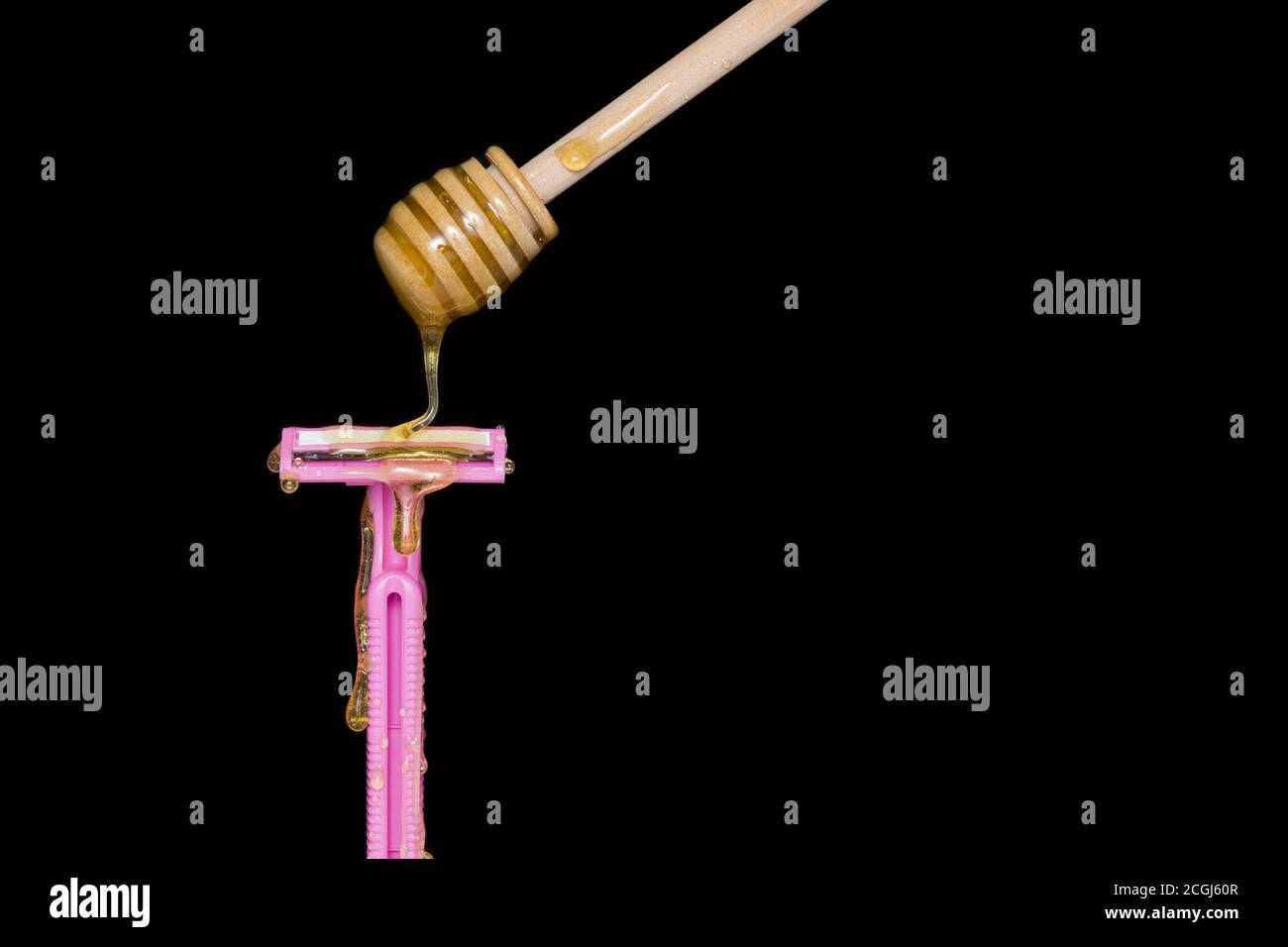 Sugar paste for sugaring or beauty wax flows from the wooden dipper to ...